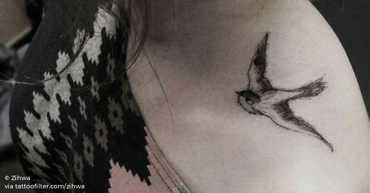 Sketchy swallow tattoo on the top of the left shoulder.