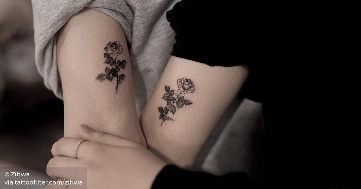 Matching blackwork rose tattoos.