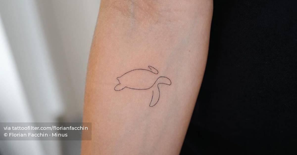 Continuous line turtle tattoo on the inner forearm.