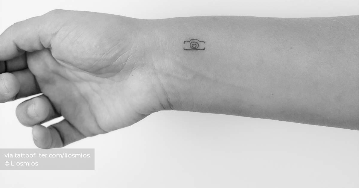 Minimalist camera tattoo on wrist