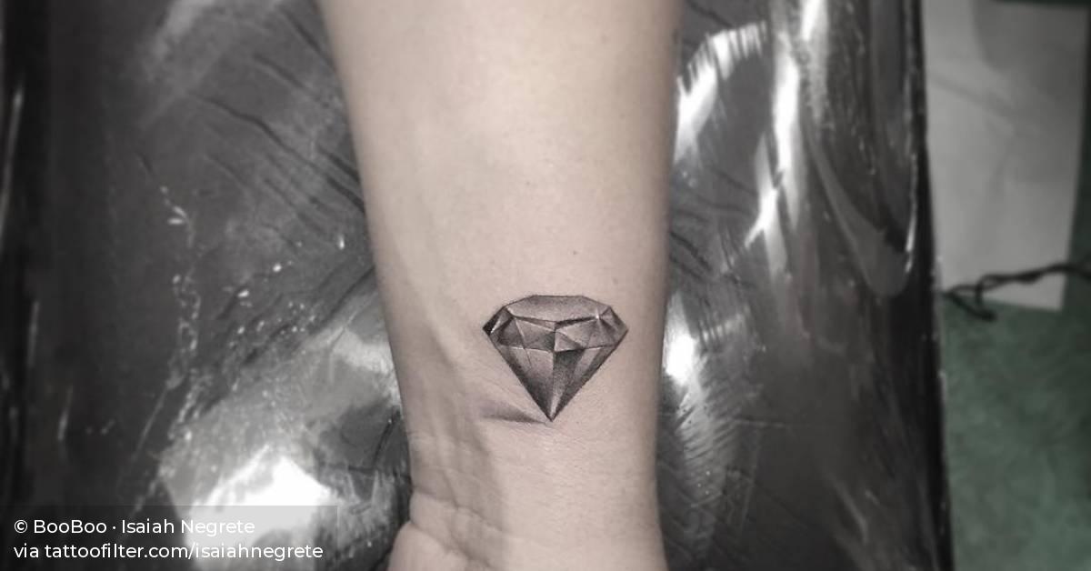Fine line diamond tattoo on the left inner wrist.