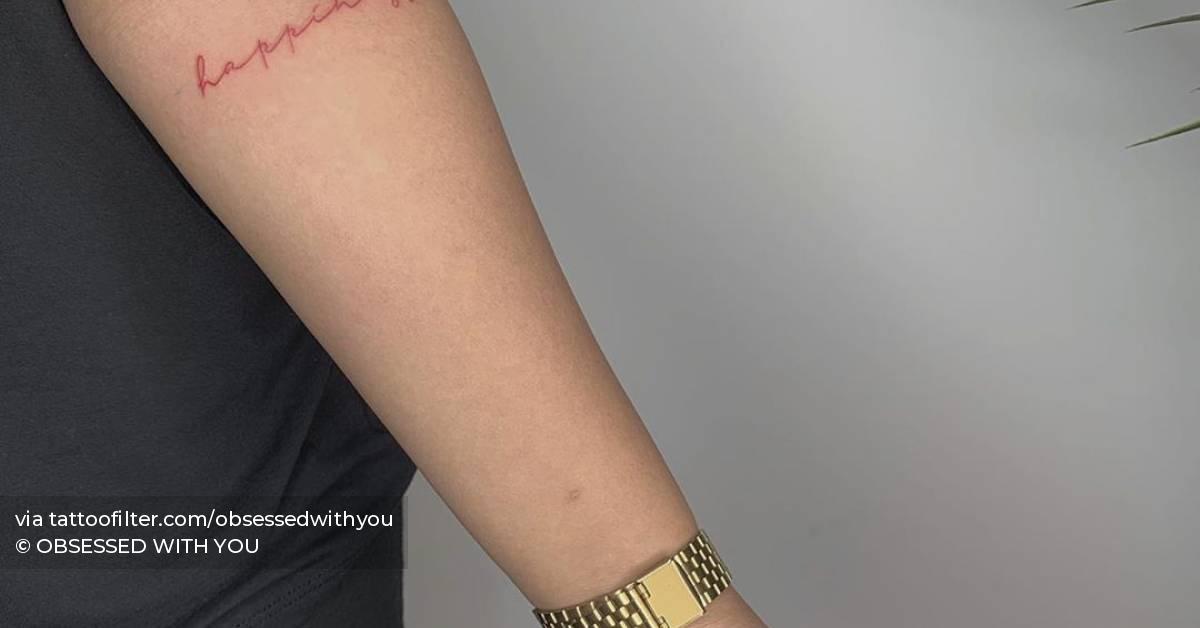 "Happiness" tattoo in red ink
