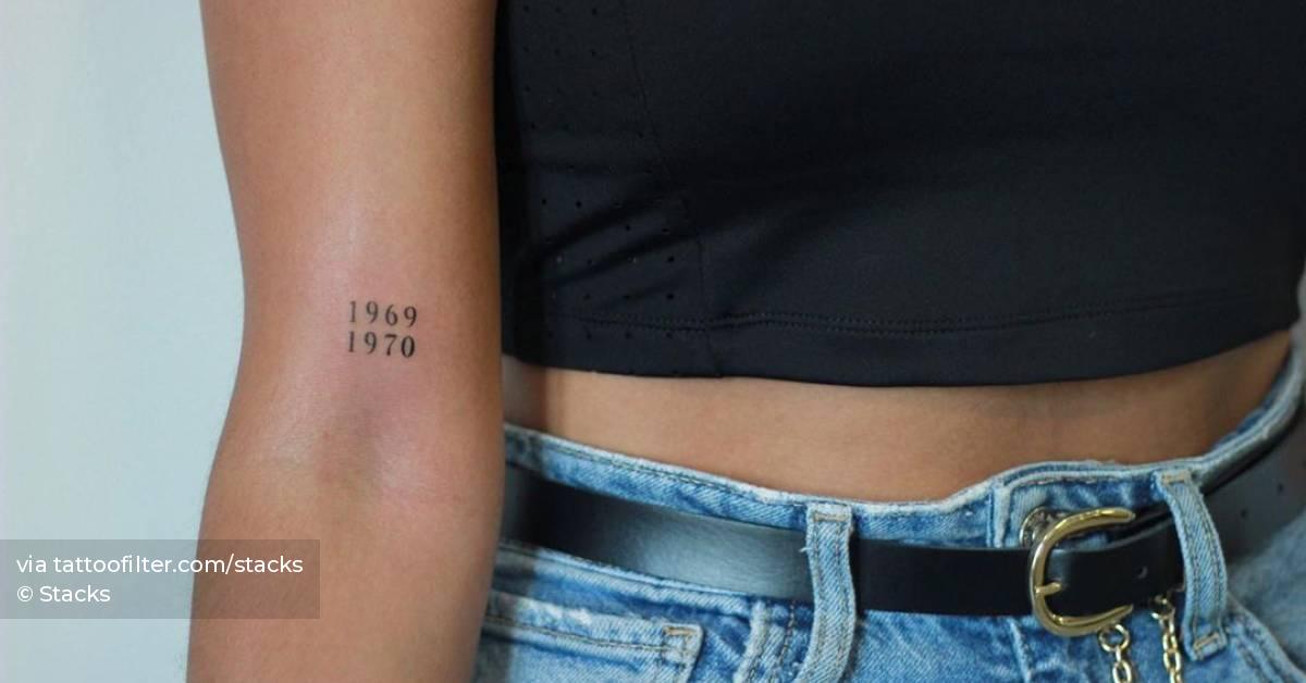 "1969" and "1970" tattooed on bicep