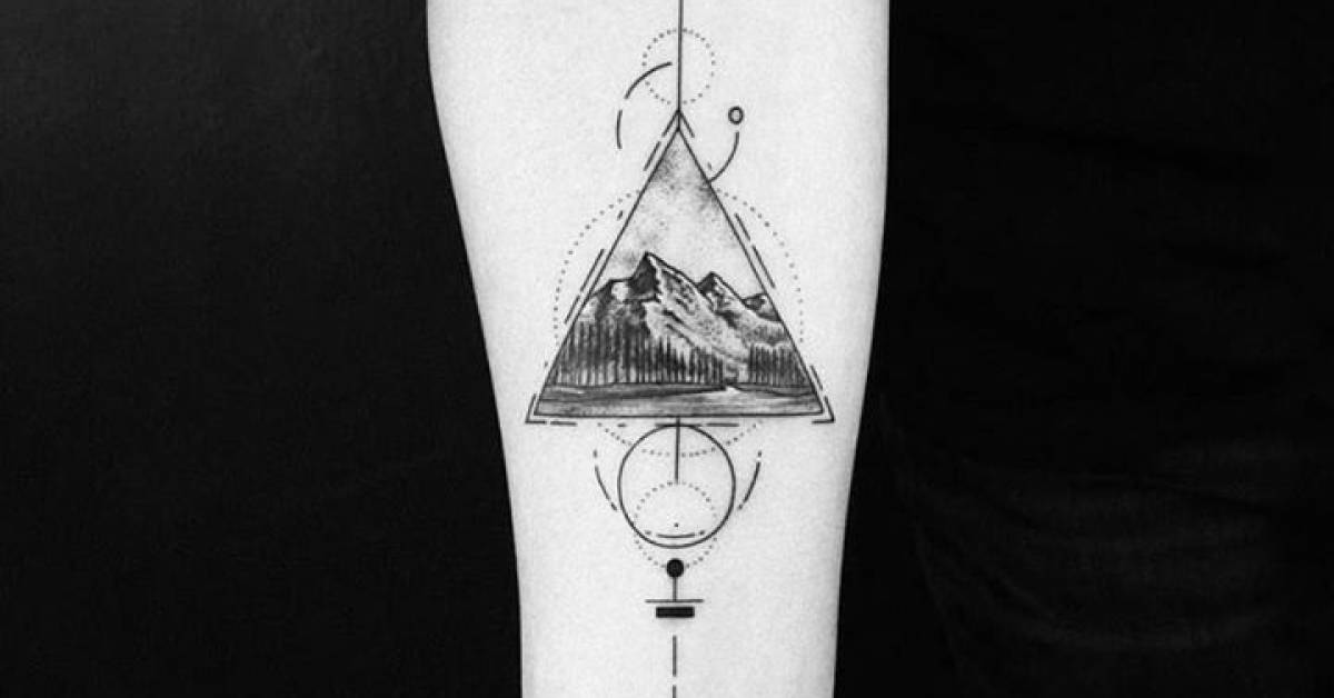 Graphic mountain tattoo on the right inner forearm.