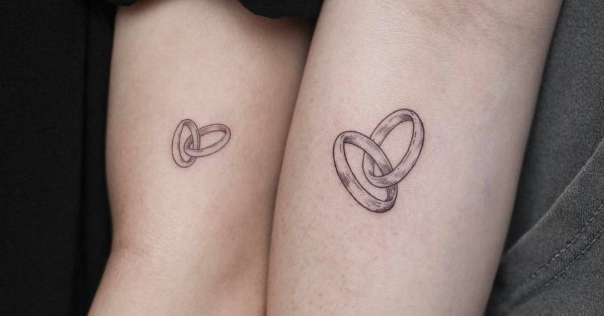 Matching wedding ring tattoos.