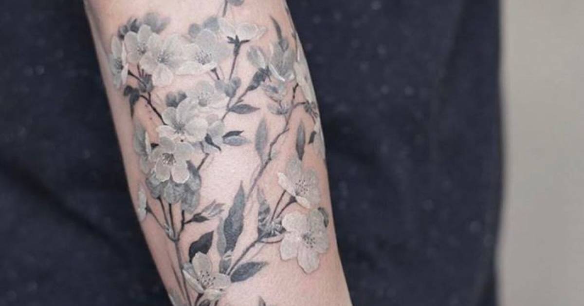 White cherry blossoms on the right forearm.