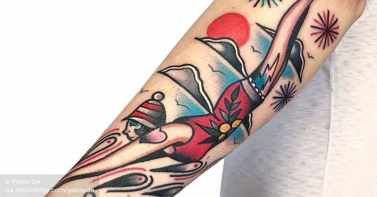 Traditional style swimmer tattoo on the left forearm.