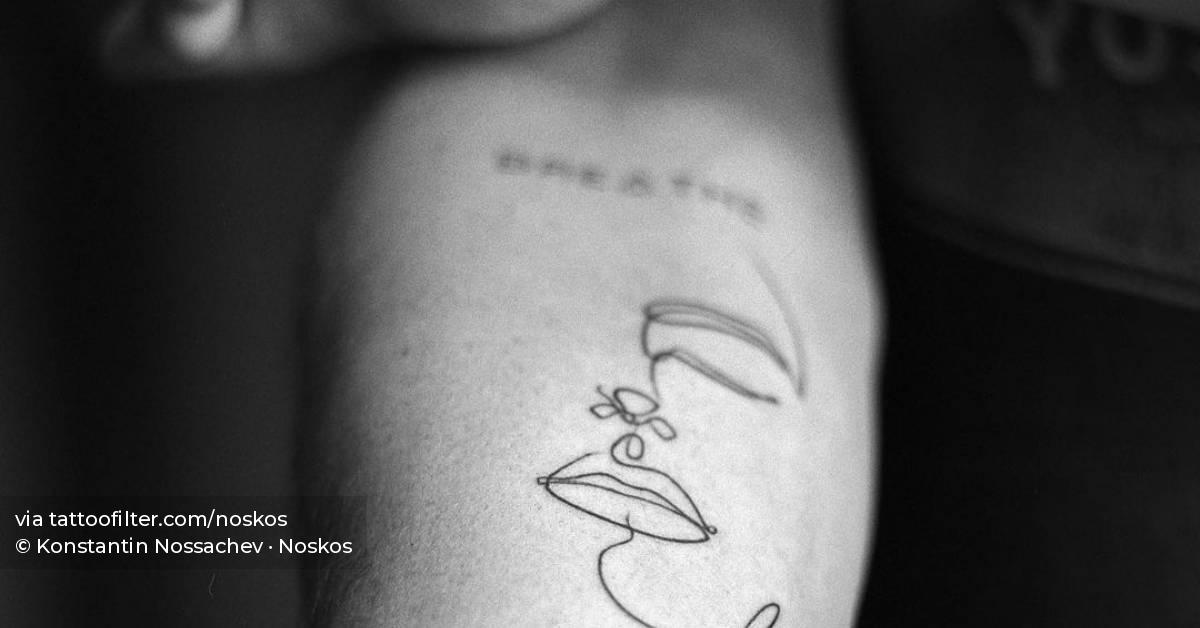 Line art face tattooed on the forearm