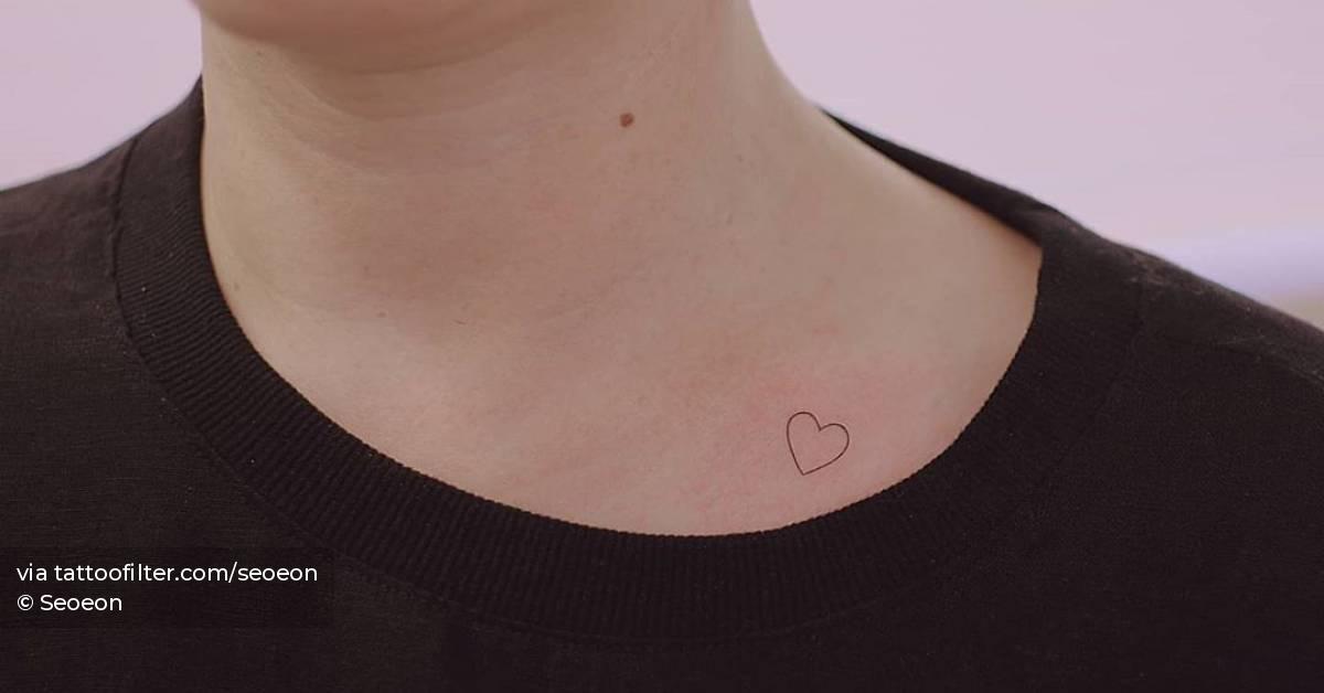Minimalist heart tattoo on collarbone