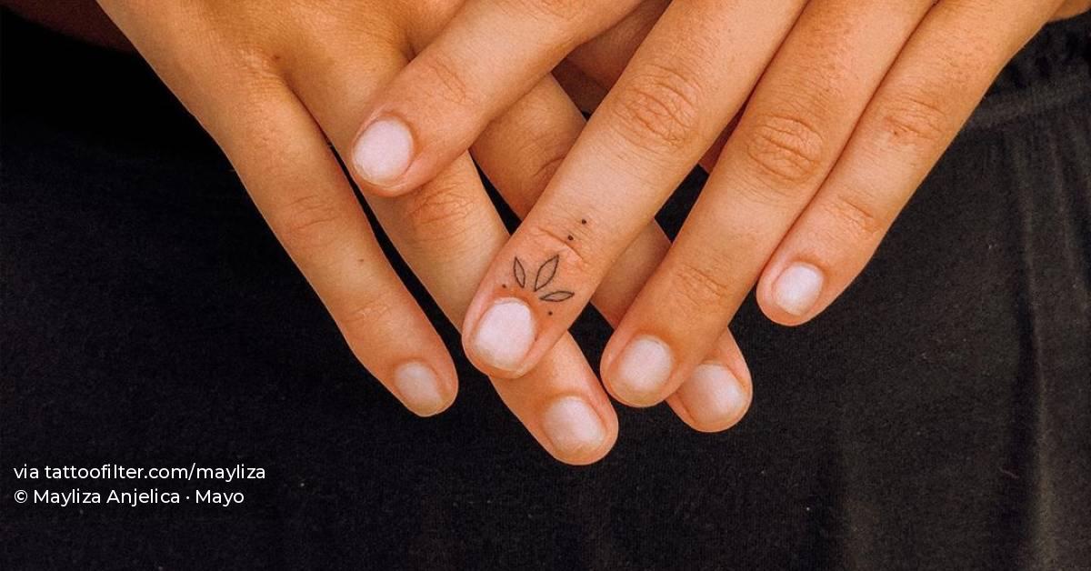 Minimalist lotus flower tattoo on finger