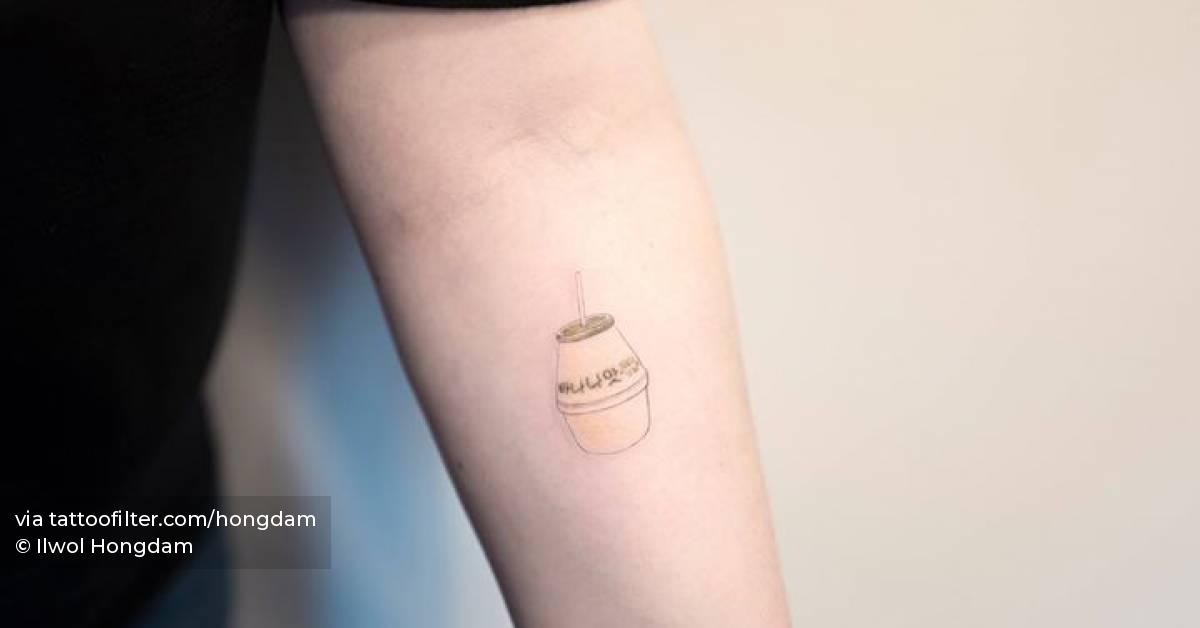 Banana flavored milk tattoo on inner forearm