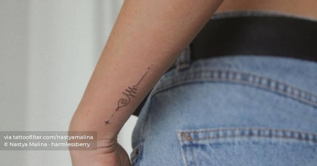 Fine line unalome tattoo on wrist