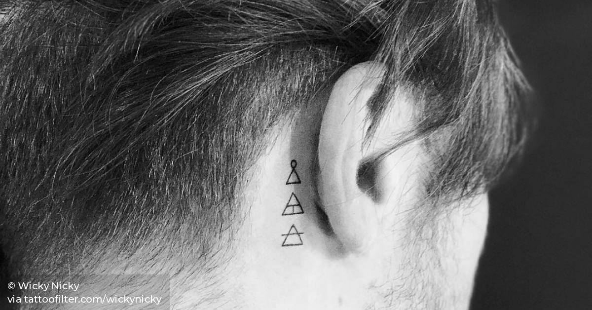 Learn, Create and Transcend glyph tattoos behind the