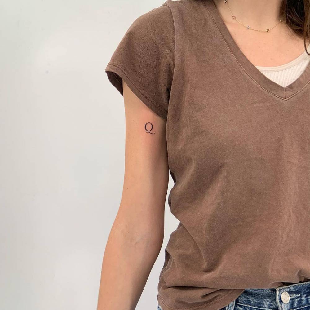 Letter Q Tattooed On Bicep