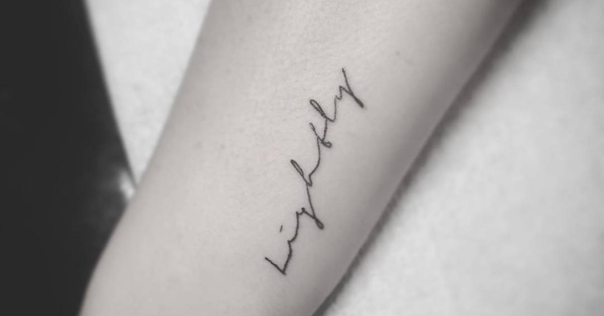 “Lightly” tattoo on Lorenza Izzo's left forearm.