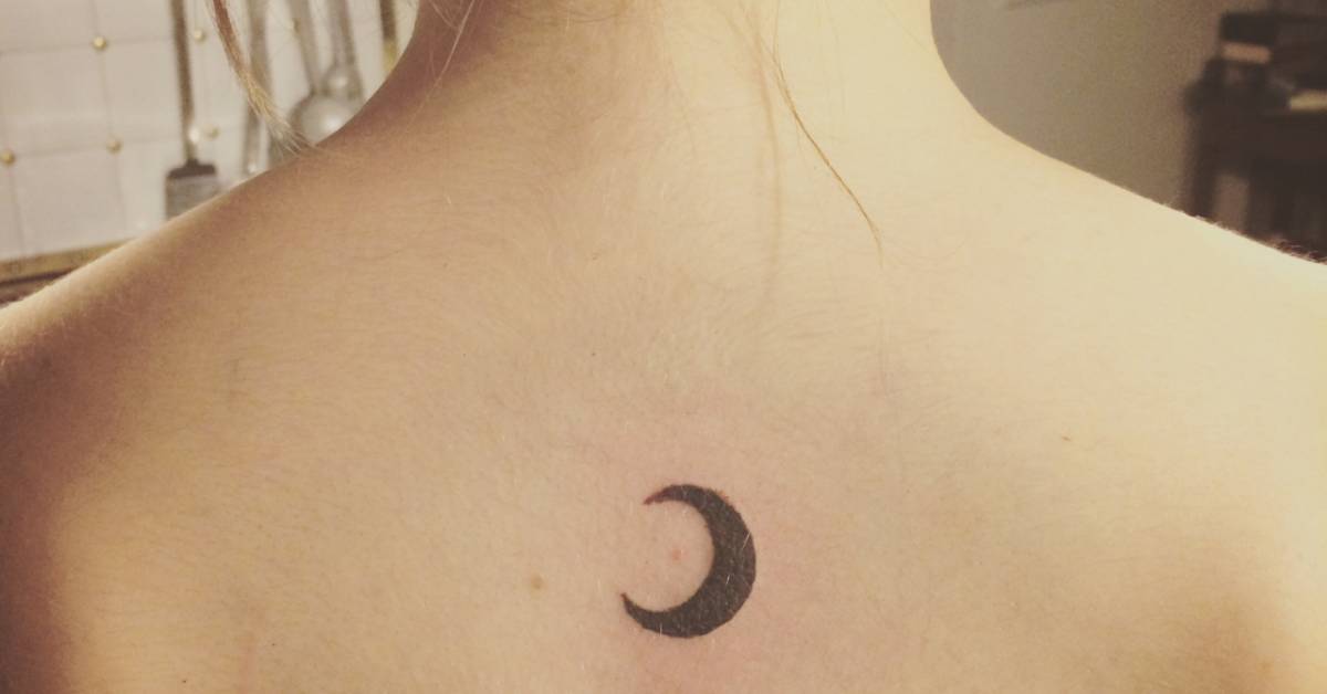 Upper back tattoo of a moon on Nicole.
