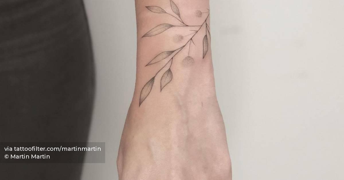 Fine line leaves tattoo on wrist