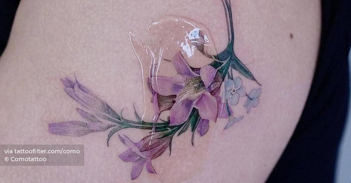 Micro-realistic lily tattoo on upper arm