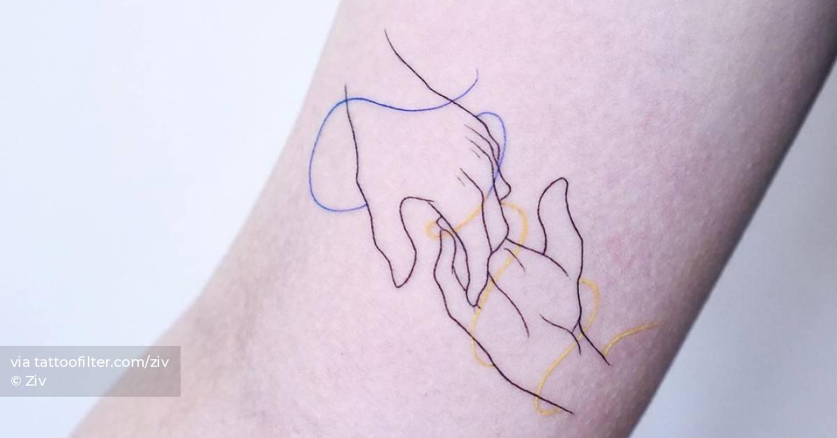 Fine line holding hands tattoo on the bicep