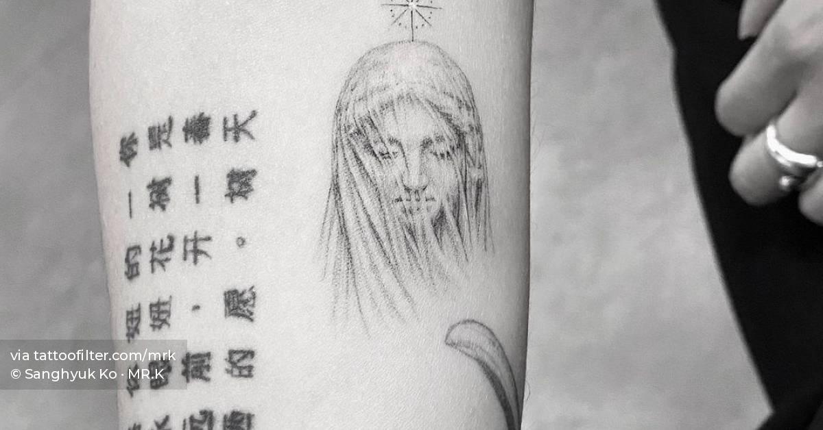 Veiled Virgin tattoo on the inner forearm