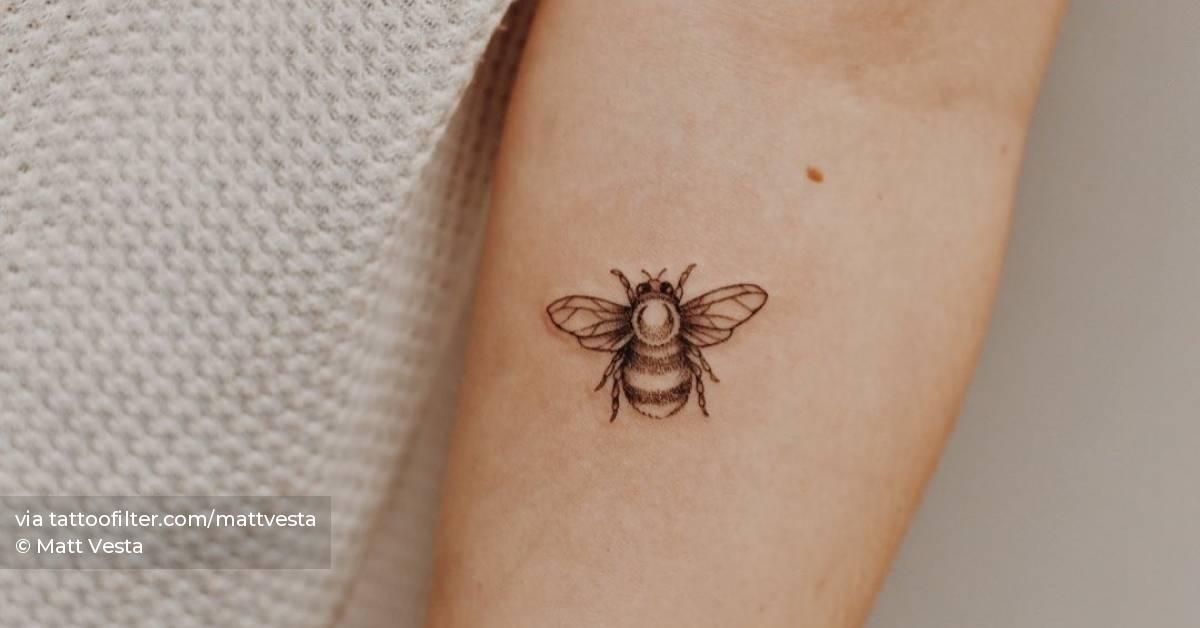 Fine line bee tattoo on the inner forearm