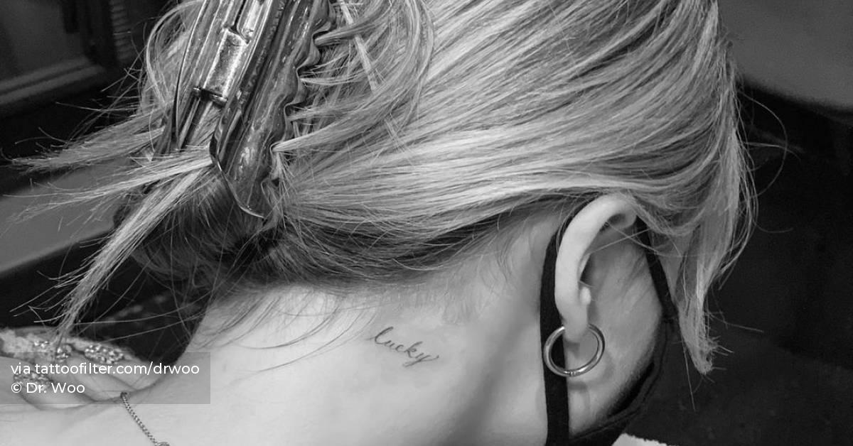 "Lucky" lettering tattoo on Sabrina Carpenter's neck
