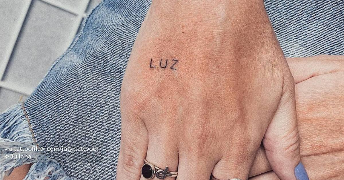 "Luz" lettering tattoo on the hand