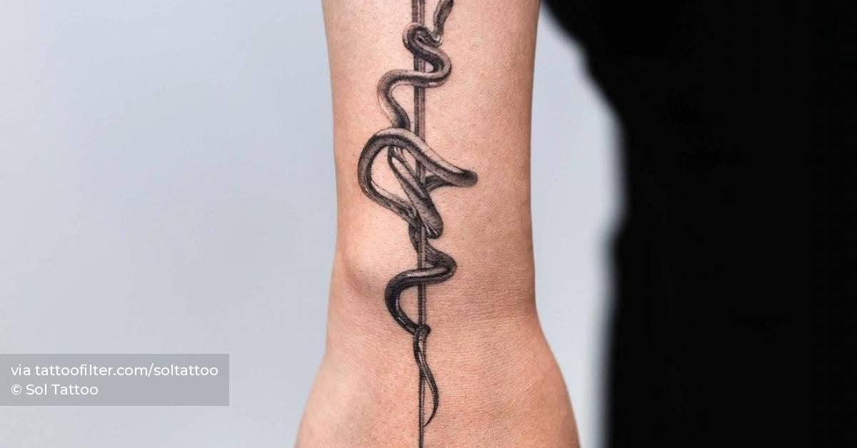 Micro-realistic snake and sword tattoo