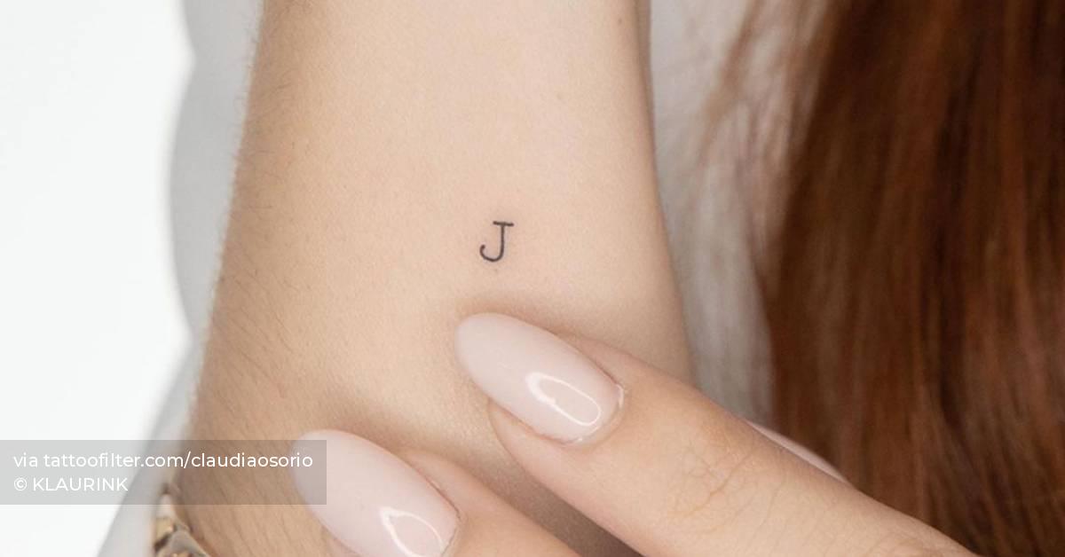 "J" lettering tattoo on the wrist