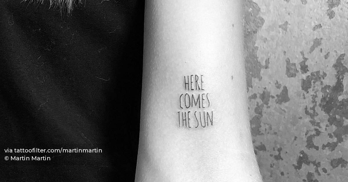 "Here comes the sun" lettering tattoo on the bicep