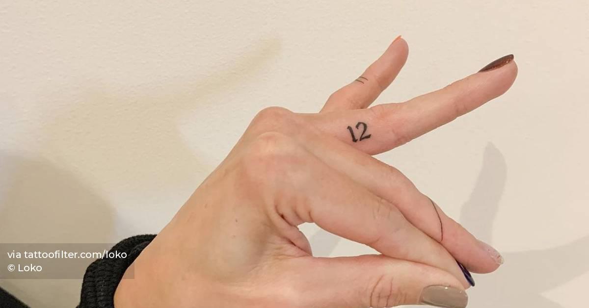 "12" tattooed on the finger