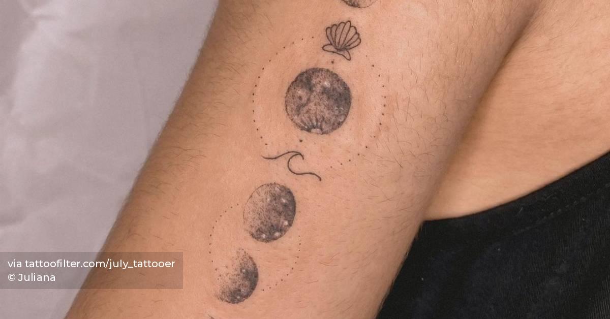 Moon phases tattoo on the upper arm