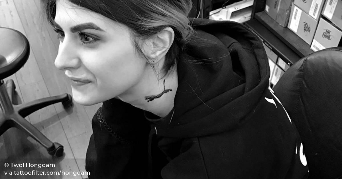 Puma logo tattoo on the left side of the neck.