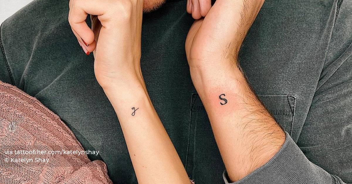 Newly weds and their initial "G" and "S" tattooed on
