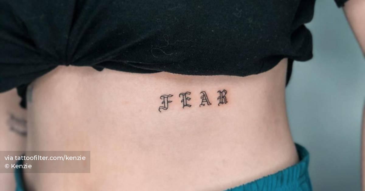 "FEAR" lettering tattoo on the rib
