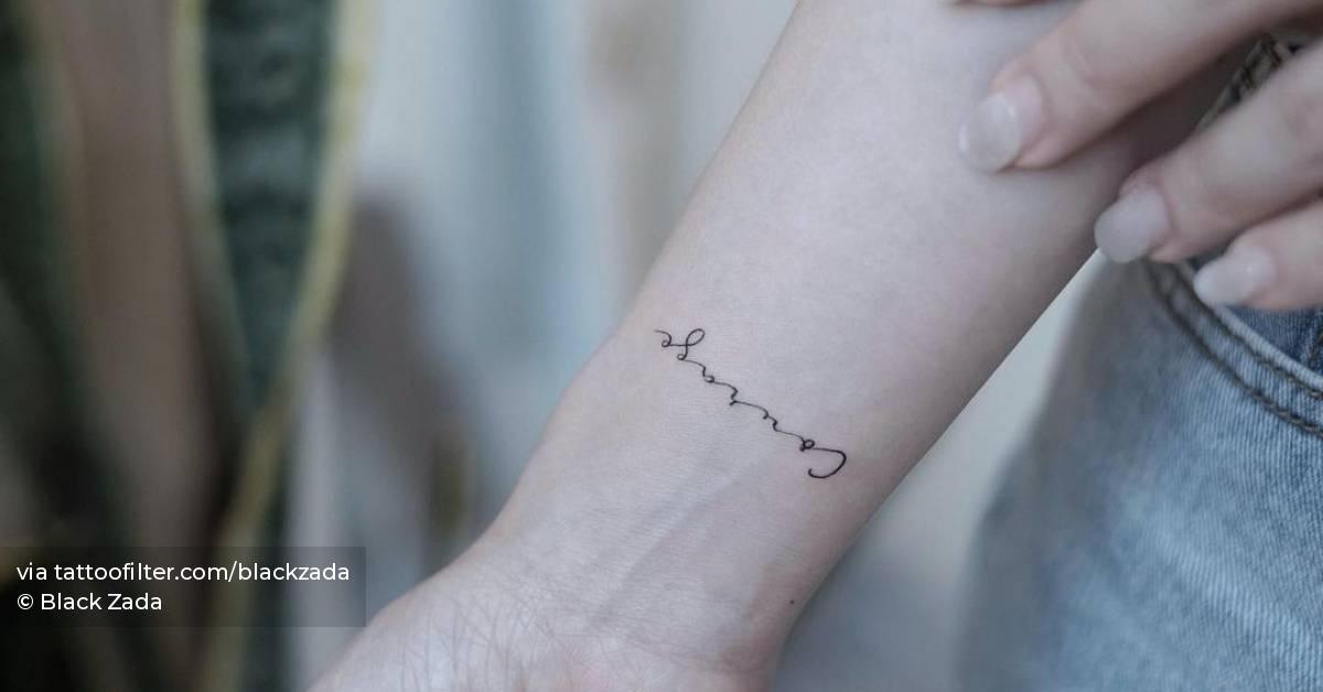 "Courage" lettering tattoo on the wrist