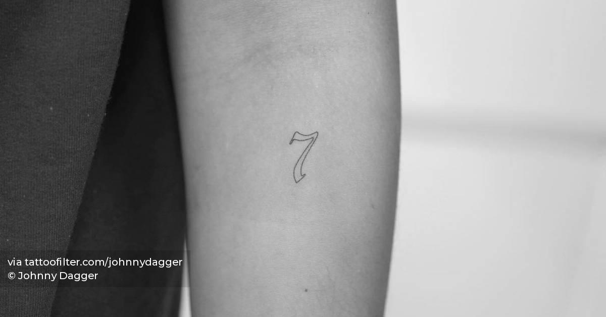 Number 7 tattooed on the inner forearm