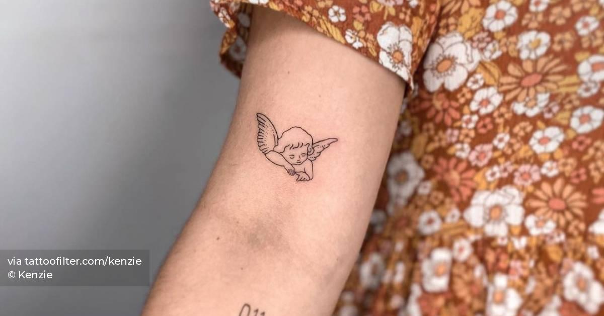 Fine line cherub tattoo on the bicep
