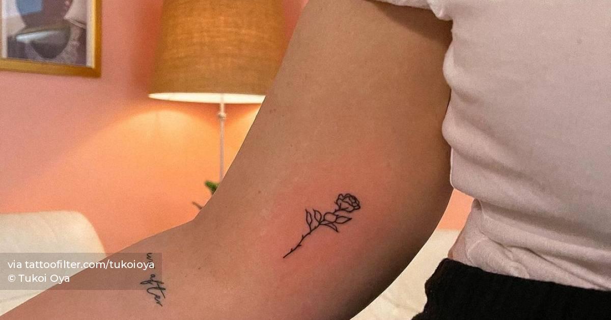 Fine line rose tattoo on the inner arm