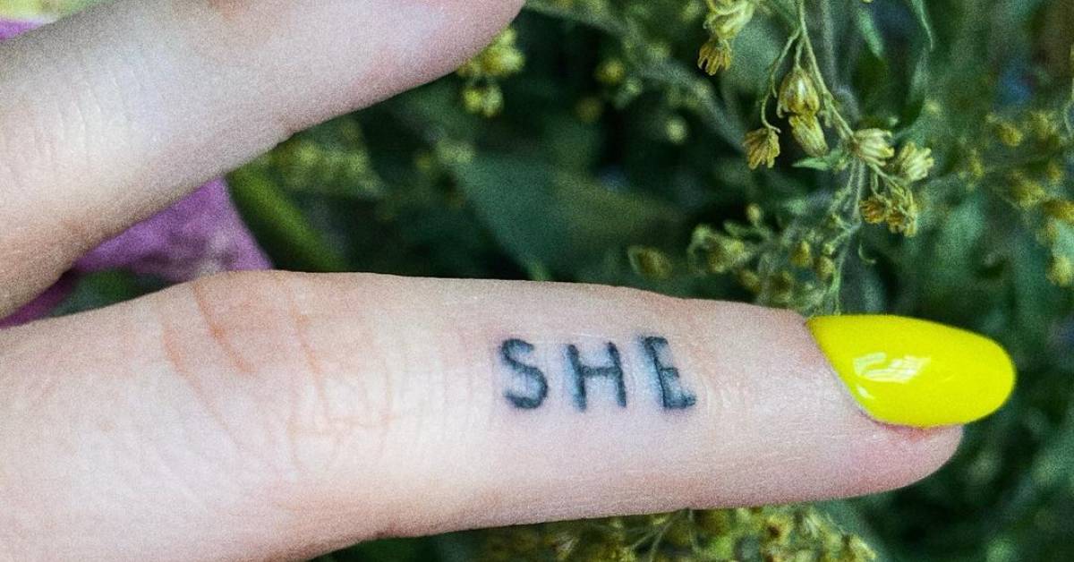 "She" lettering tattoo on Dove Cameron's finger