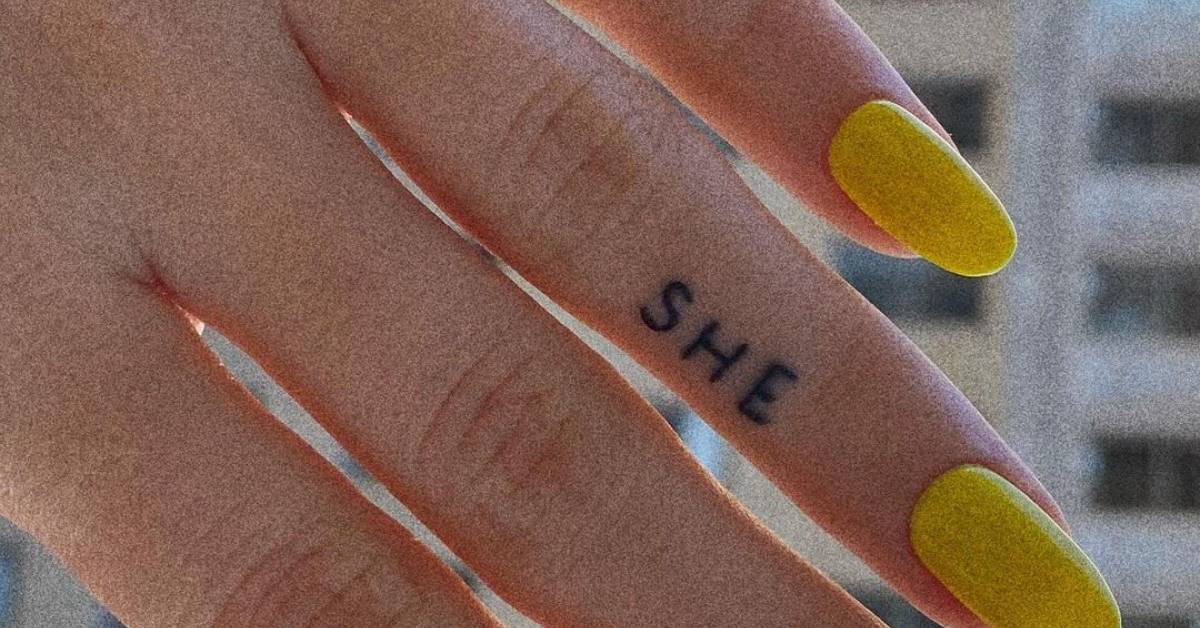 "She" lettering tattoo on Dove Cameron's finger