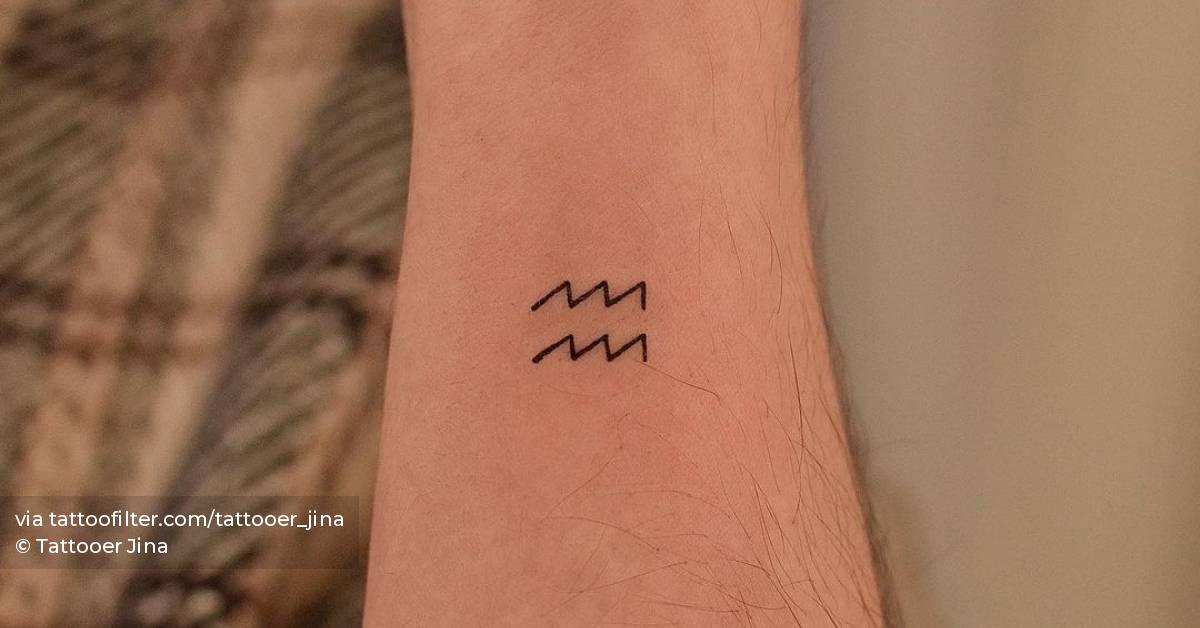 Aquarius zodiac symbol tattoo on the wrist