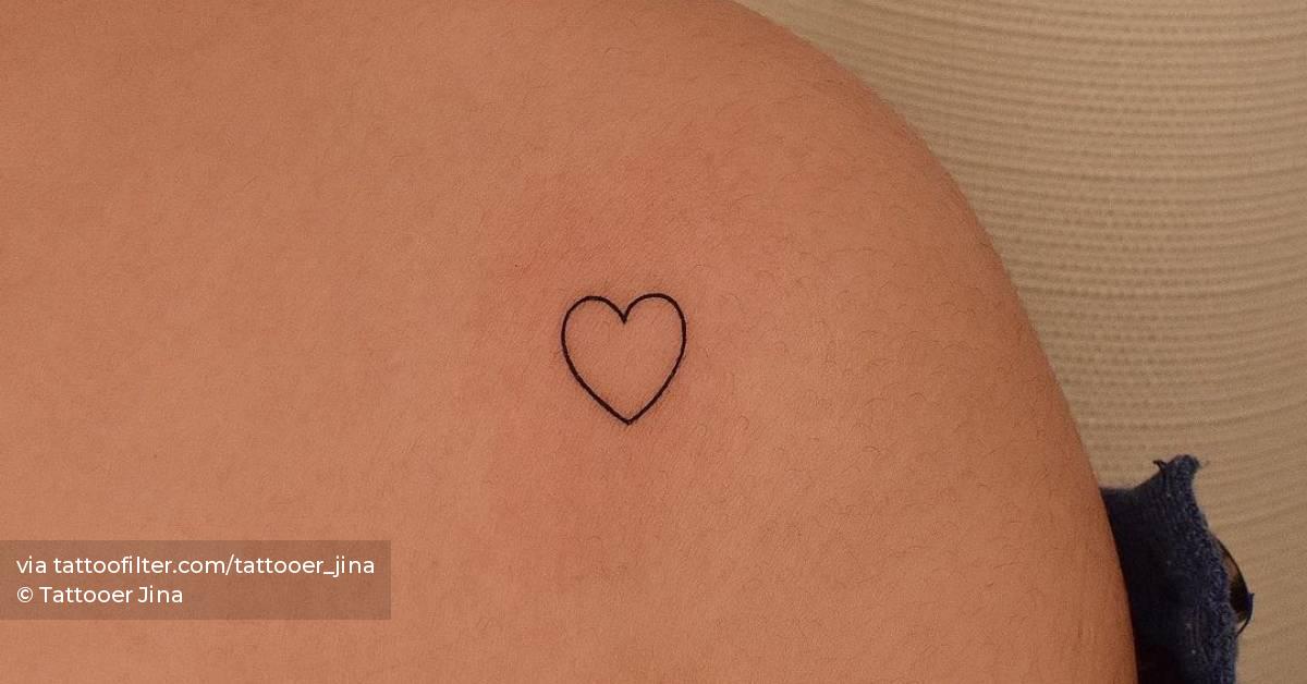 Minimalist heart tattoo on the shoulder