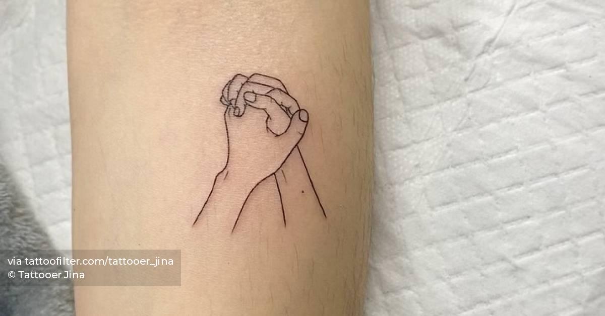 Fine line holding hands tattoo on the inner forearm