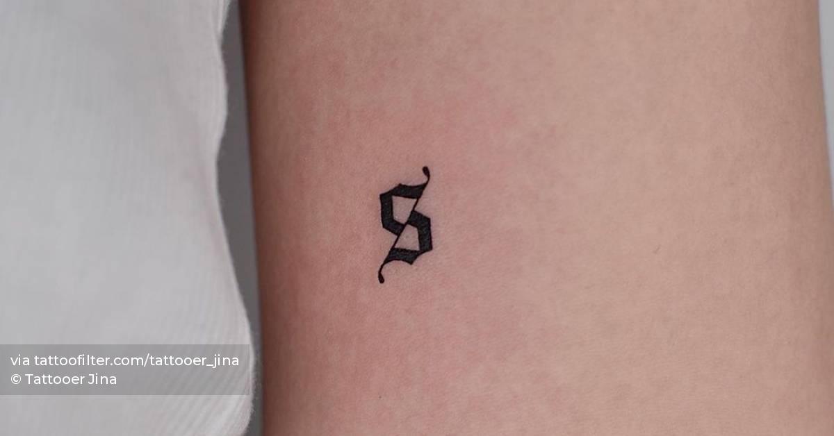 Letter "S" tattooed on the bicep