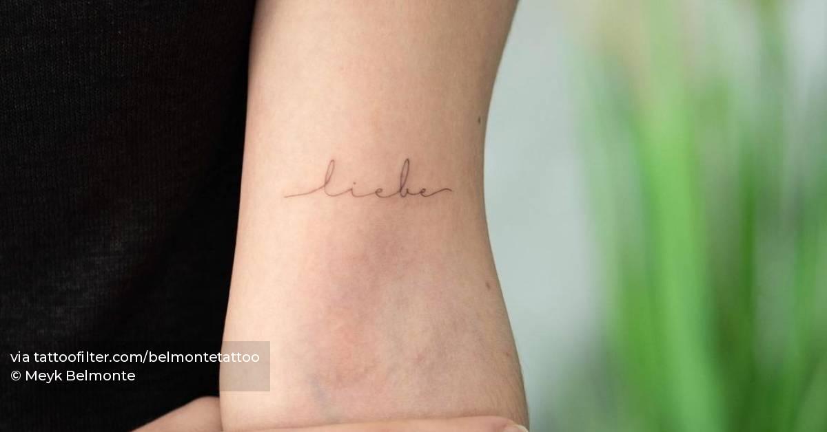 "Liebe" lettering tattoo on the bicep
