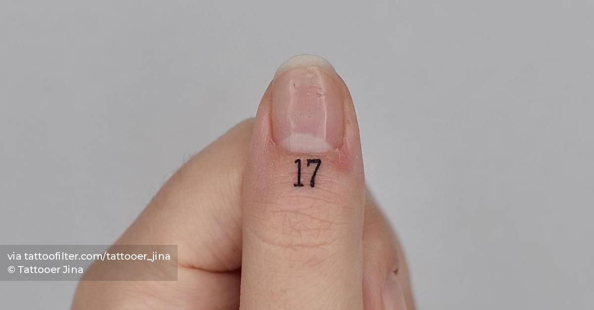 Number "17" tattooed on the thumb