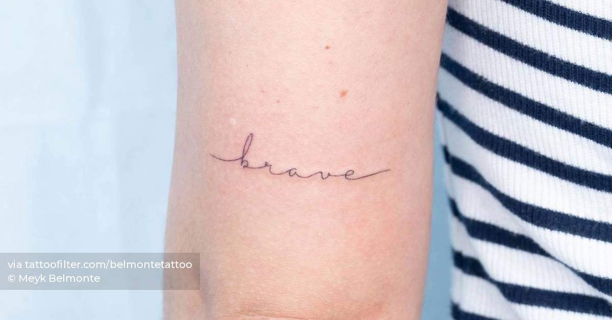 "Brave" lettering tattoo on the tricep