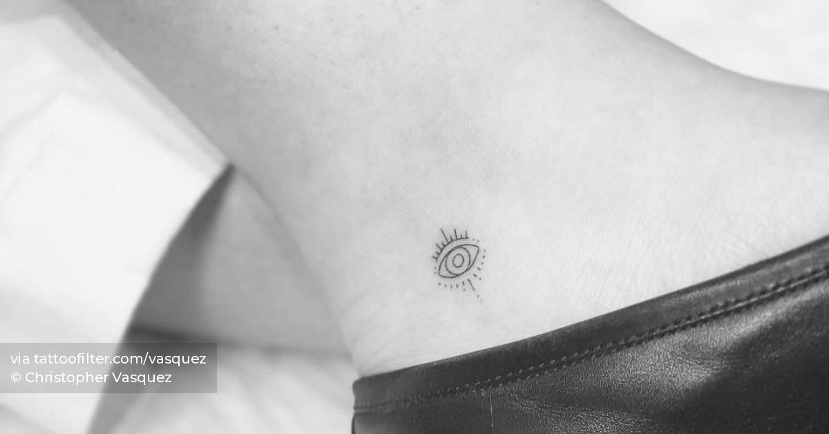 Fine line evil eye tattoo on the ankle