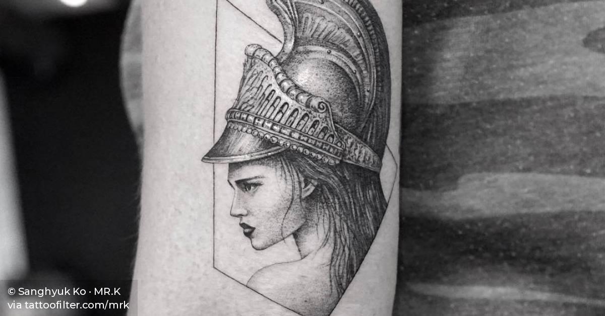 Nemesis portrait tattoo on the back of the left arm.